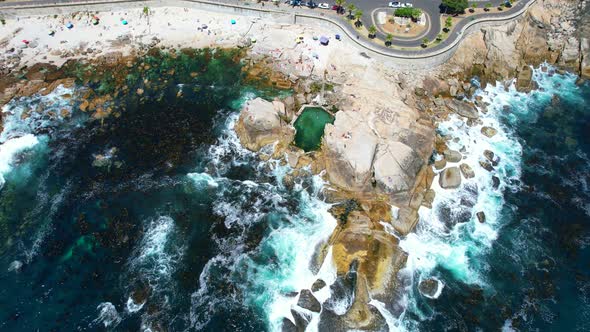 aerial top down view of Saunders Rocks Beach waves crashing into ...