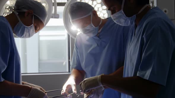 Multi-ethnic group of male and female surgeons working together in a ...