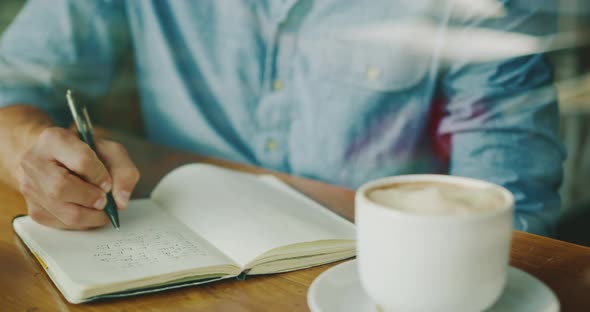 Man Writing in Coffee Shop, Stock Footage | VideoHive