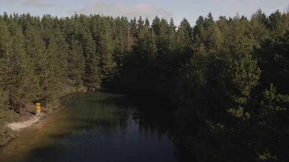Calm Lake Water Surrounded By Lush Pine Trees At Abandoned Quarry Of ...