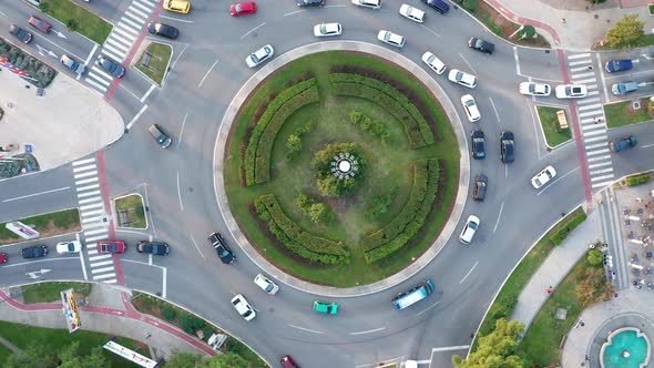 Vehicles on a busy roundabout junction. Traffic circle with a lot of ...