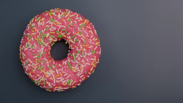 Pink Donut with Colorful Sprinkles Rotating. Colorful Doughnut Spinning ...