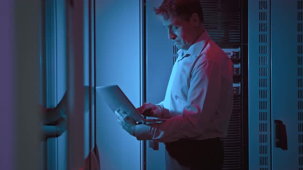 Middle-Aged Data Center Technician at Work, Stock Footage | VideoHive