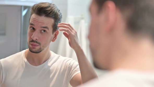 Young Man Fixing Hair in Mirror, Stock Footage | VideoHive