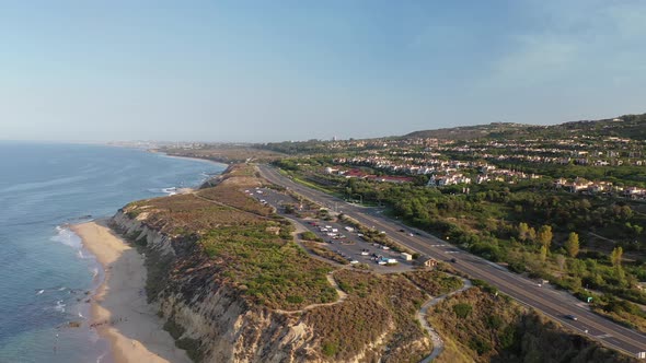Stunning 4 k aerial drone shot gliding over the ocean as luxury homes ...