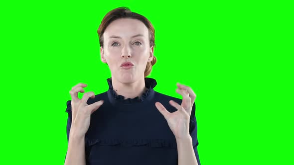 Angry Caucasian woman calling out on green background, Stock Footage