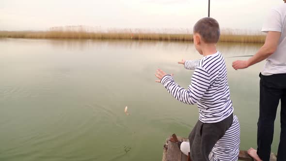 A Boy Grab a Fish Caught on a Fishing Trip, Stock Footage | VideoHive