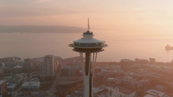 Orbiting aerial the Space Needle with a smoke filled sunset over the ...