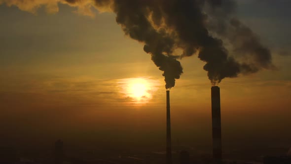 Power Plant emissions seen above the city during sunrise. Environmental ...