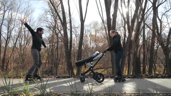 Happy Family. Young Parents Roller Skating with a Child in a Stroller ...