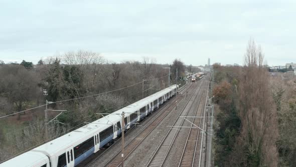 Overhead profile follow drone shot of elizabeth line TfL rail train ...