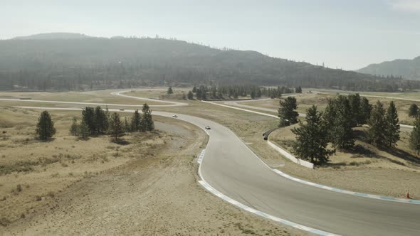 McLaren cars driving on motor racing circuit, Osoyoos race track ...