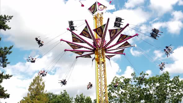 Carnival ride swings riders over fair ground, Stock Footage | VideoHive