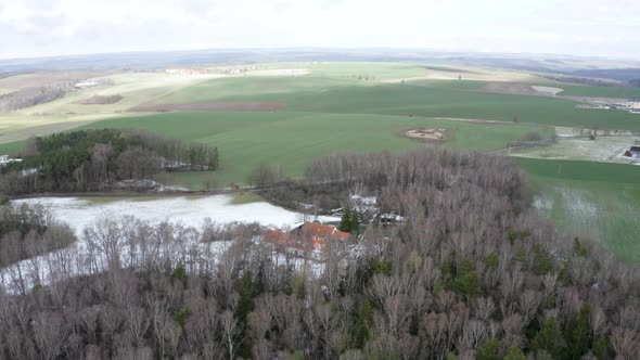 Secluded farm ranch in leafless tree grove and snowy field, Czechia ...
