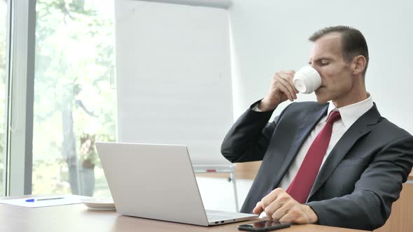 Businessman Drinking Coffee at Work, Stock Footage | VideoHive