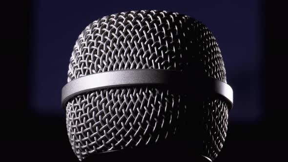 The Microphone Rotates on a Black Background. Dynamic Microphone Grid ...
