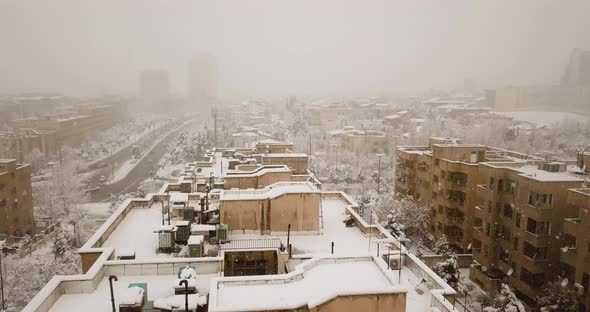 Fly over buildings rooftop during the heavy snowfall in Tehran Iran ...
