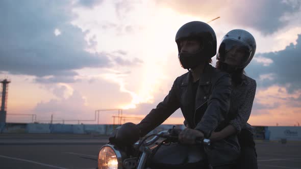 Young Couple in Helmets Riding on Motorcycle in City During Sunset Slow ...