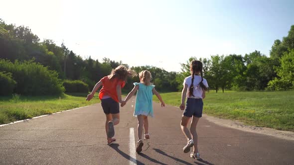 Back View Three Little Girls Run on the Street, Stock Footage | VideoHive
