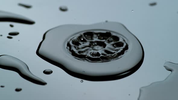 Water drip into puddle closeup , slow motion, shot on Phantom Flex 4K ...