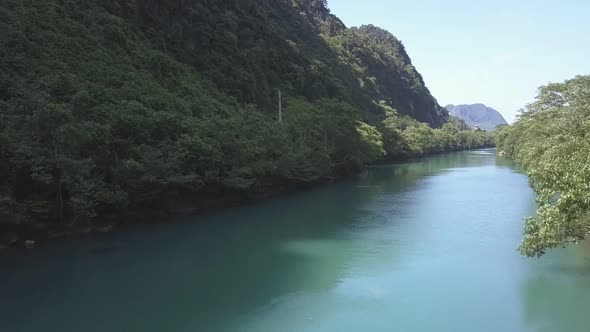 Motion Close Above Calm Blue River with Forestry Banks, Stock Footage