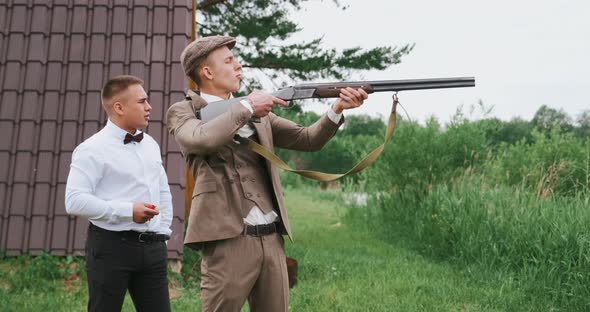 Team of Two Men Shooting the Gun They Wear Old Retro Clothes As ...