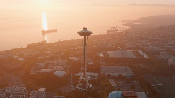 Establishing wide aerial of the Space Needle during sunset with a layer ...