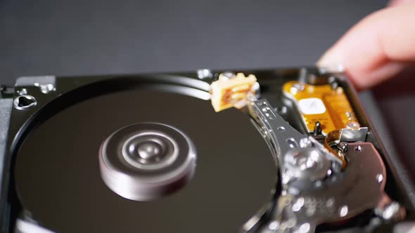 Opened Hard Disk Drive with Spinning Platter. Move of Magnetic Head ...
