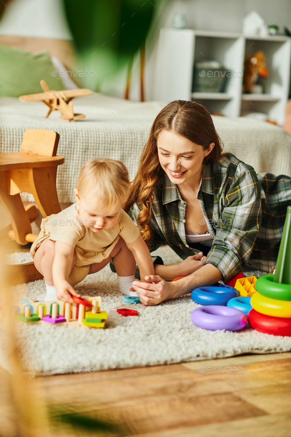 Joyful bonding: mother and baby playtime Stock Photo by LightFieldStudios