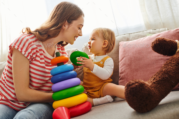 Joyful bonding: mother and daughter playtime Stock Photo by LightFieldStudios