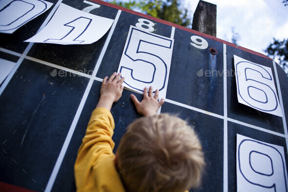 Little child reaching for numbers on a scoreboard Stock Photo by Image ...