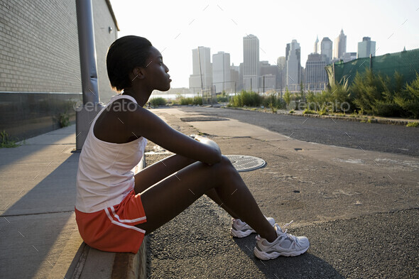 Runner sitting on sidewalk Stock Photo by Image-Source | PhotoDune