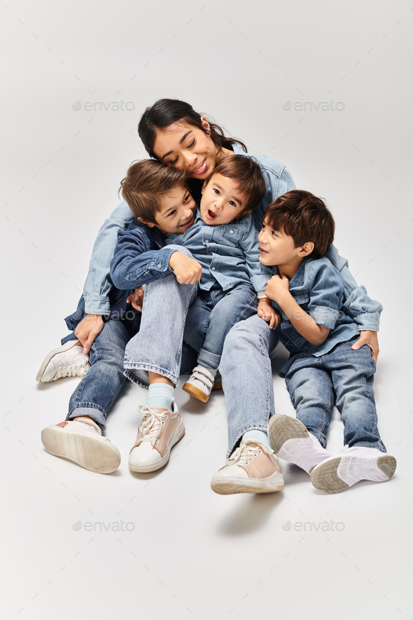 Denim tower: a playful stack of children Stock Photo by LightFieldStudios