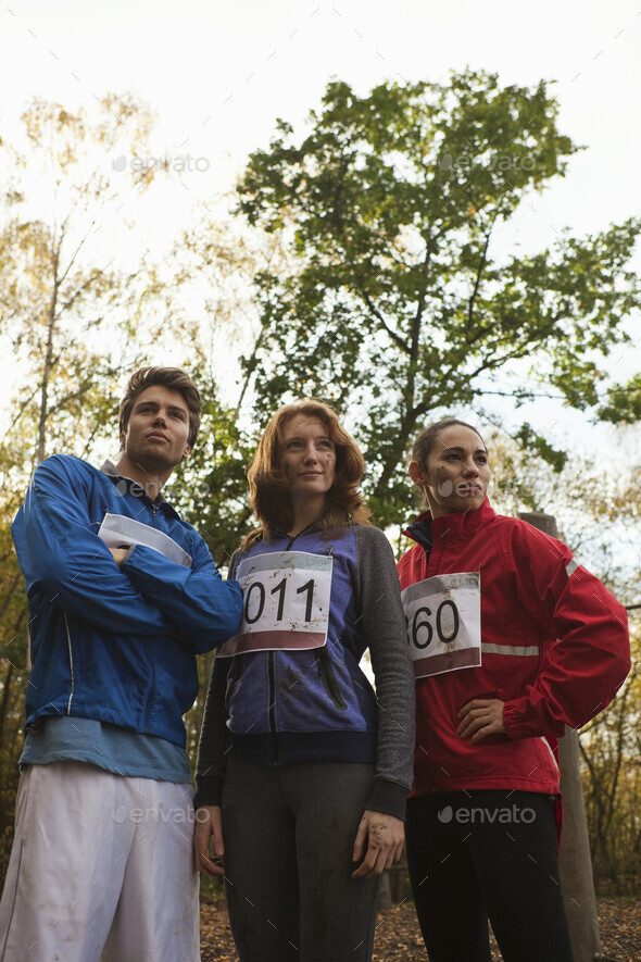 Three determined runners ready for the race in a woodland setting Stock ...