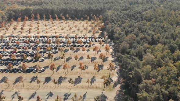 Sideway aerial drone shot of a parking space in the middle of a forest ...