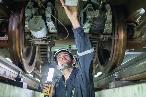Railway technicians inspect the suspension brakes and axle stability ...
