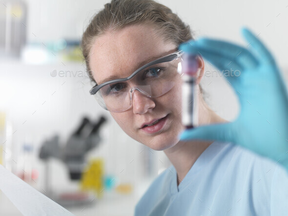 Technician holding bar coded blood sample in clinical laboratory Stock ...