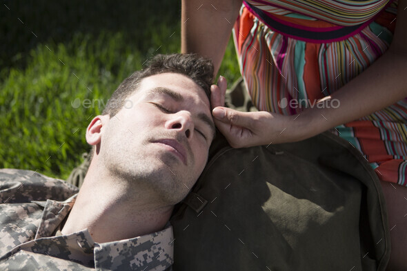 Overhead close up view of anxious male soldier with wife soothing his ...