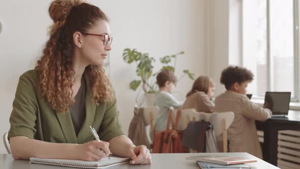 Teacher Taking Notes in Classroom Posing, Stock Footage | VideoHive