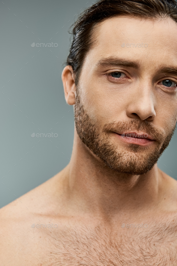 Glistening adonis: shirtless man poses Stock Photo by LightFieldStudios