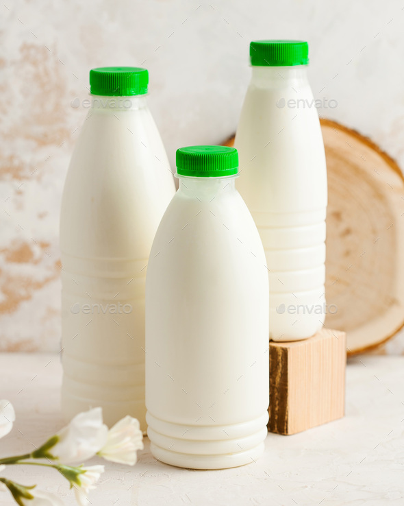 Triple set of dairy bottles with green caps, symbolizing freshness and ...