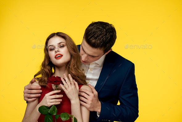 Gentlemen in classic suit on yellow background and red rose romance ...
