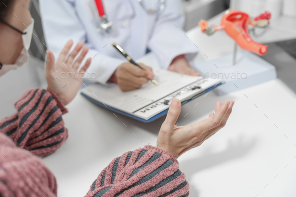 female doctor reassuring patient with comforting hand gesture, with ...