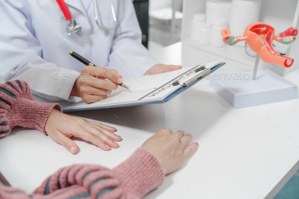 female doctor reassuring patient with comforting hand gesture, with ...