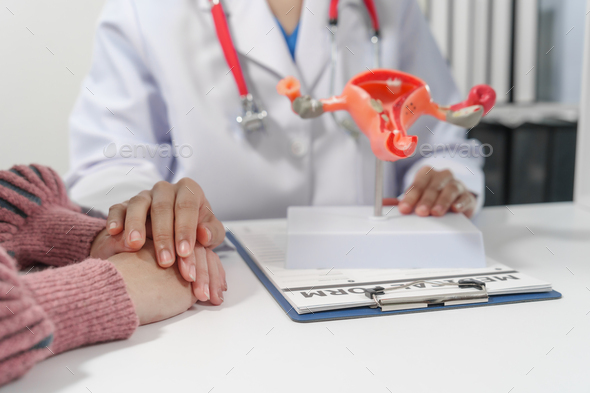 female doctor reassuring patient with comforting hand gesture, with ...