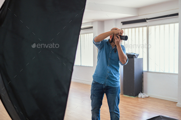 Photographer shooting a model in a studio with a softbox Stock Photo by ...