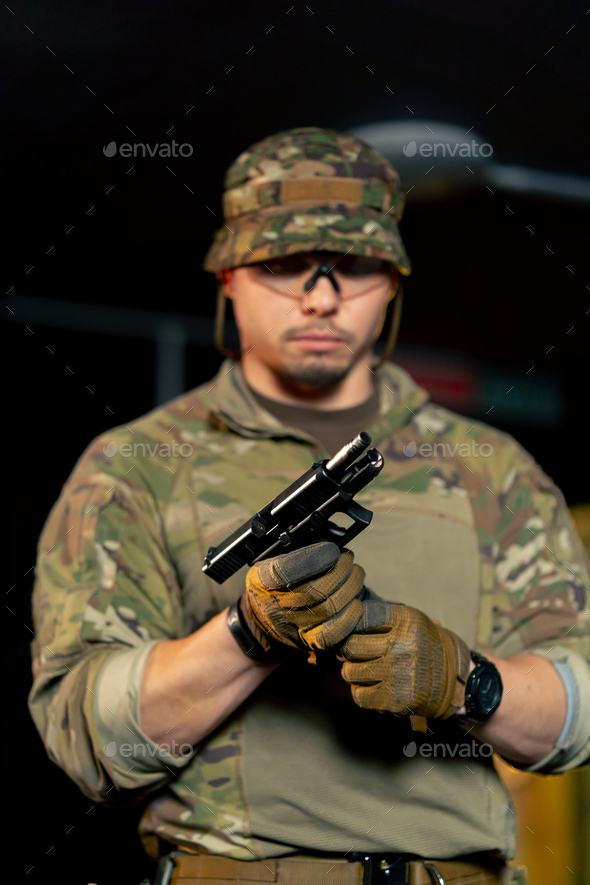 close-up at a professional shooting range a military trainer reloading ...
