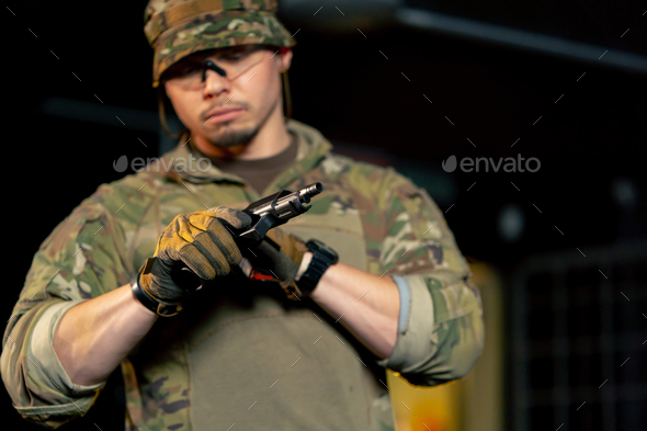 close-up at a professional shooting range a military trainer reloading ...