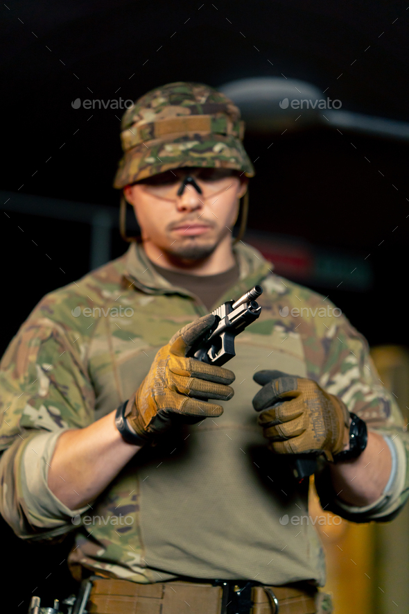 close-up at a professional shooting range a military trainer reloading ...