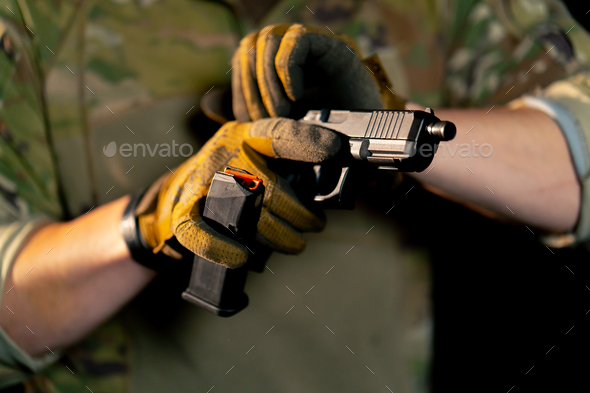 close-up at a professional shooting range a military trainer reloading ...